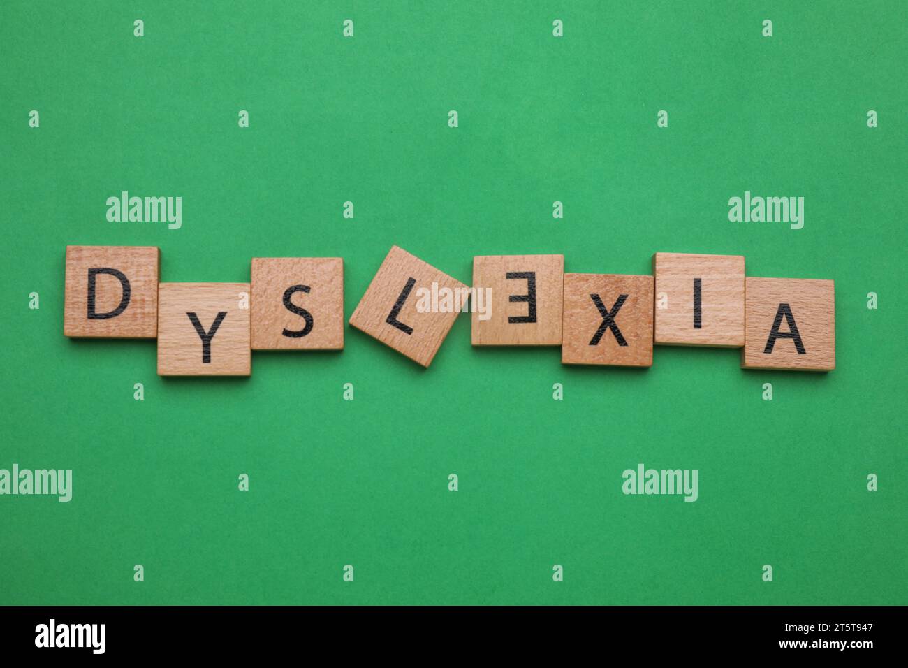 Word Dyslexia with inverted letter E of wooden tiles on green ...