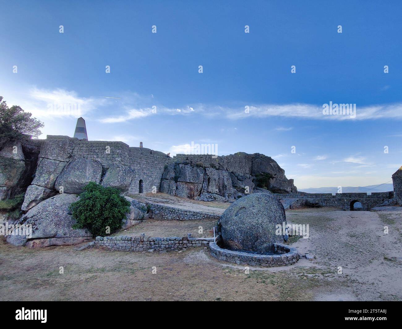 A breathtaking view of the famous Monsanto Castle in Portugal, atop a ...