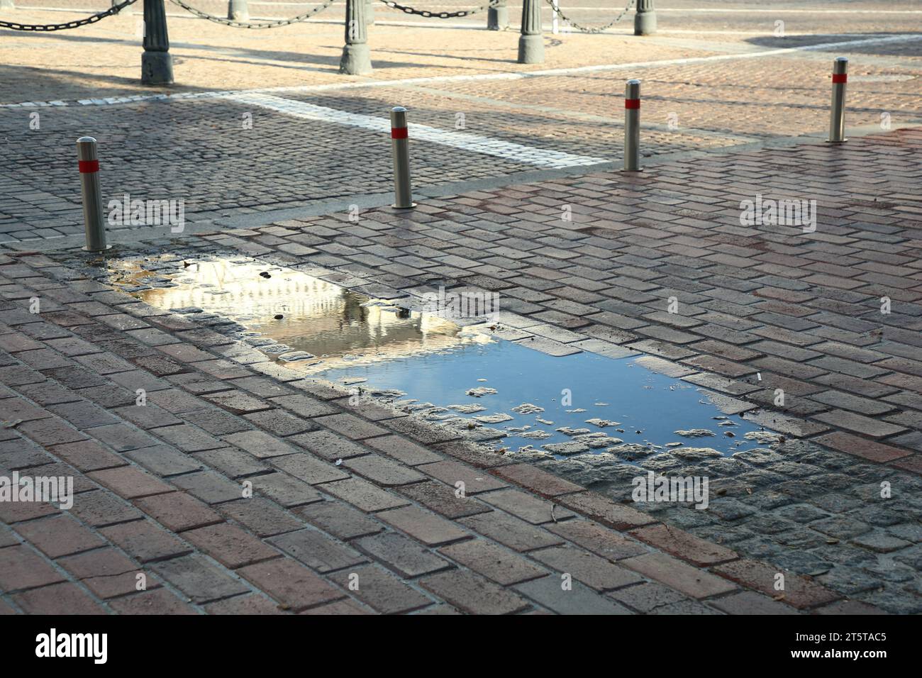 Puddle of rain water on paved pathway outdoors Stock Photo - Alamy