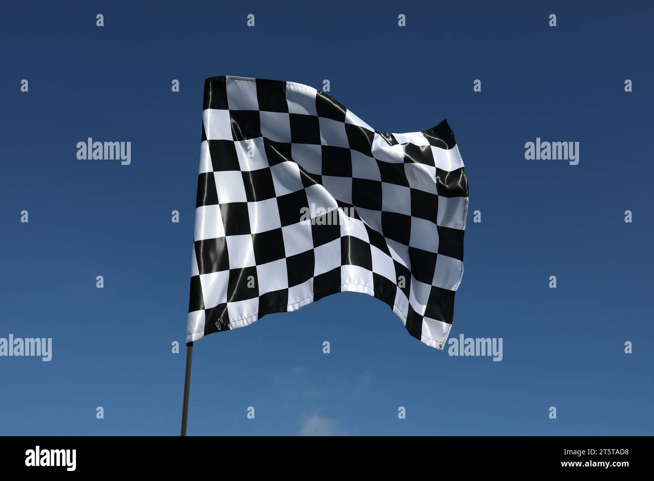 One checkered flag against blue sky outdoors Stock Photo - Alamy