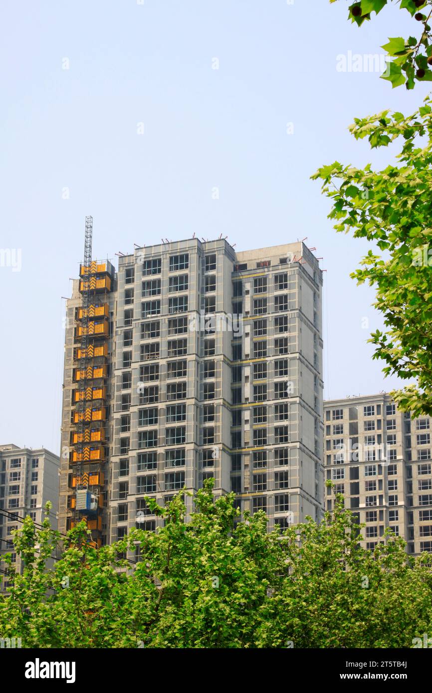 Unfinished buildings and green, closeup of photo Stock Photo - Alamy