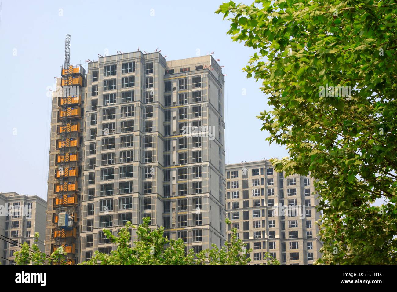 Unfinished buildings and green, closeup of photo Stock Photo - Alamy