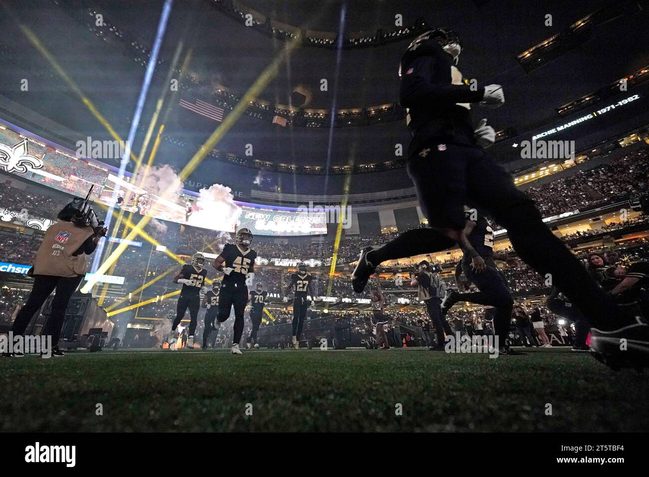 New Orleans Saints players run onto the field during player ...
