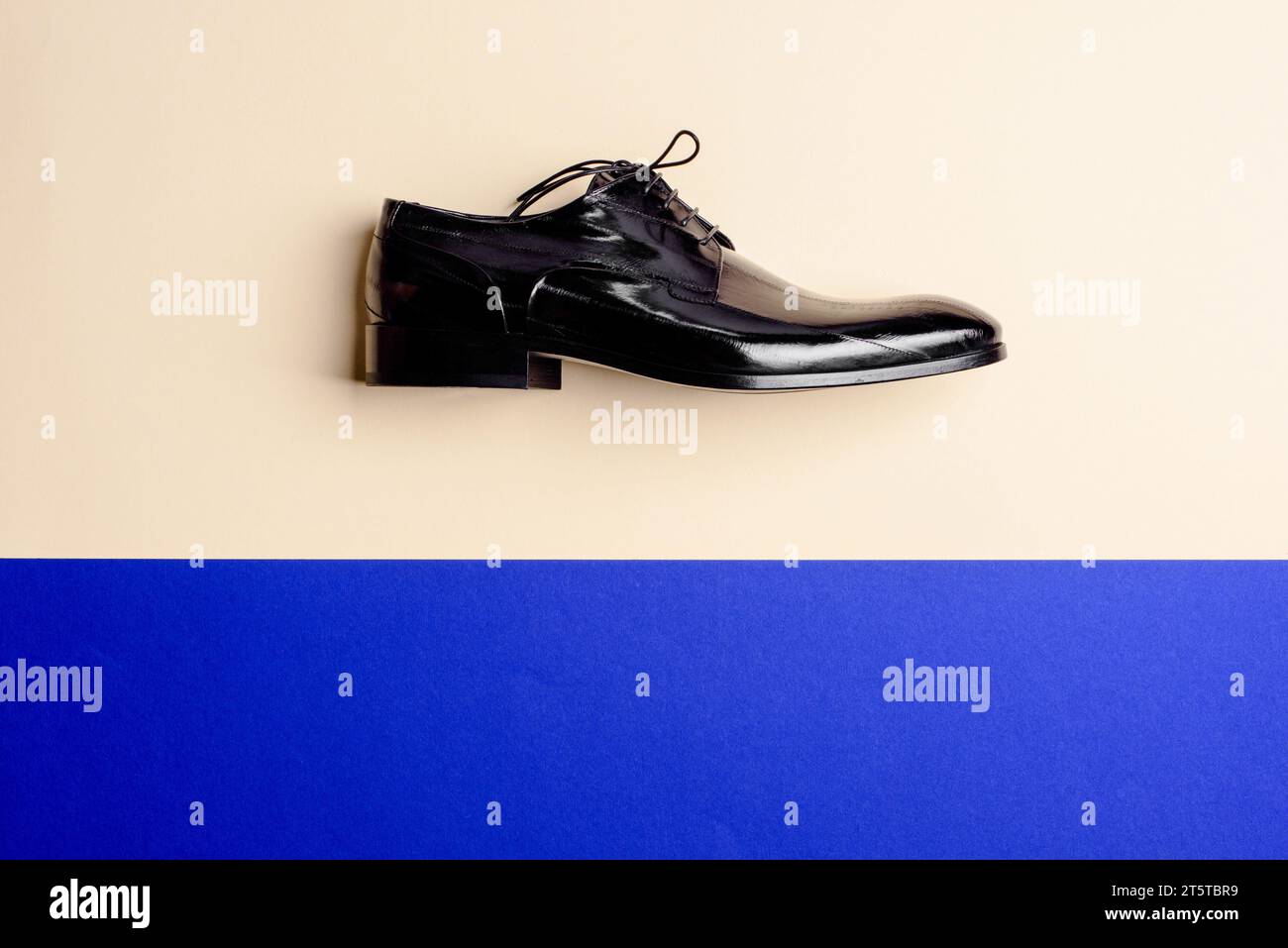 Side view of men's elegant black patent leather shoe on a contrast ...