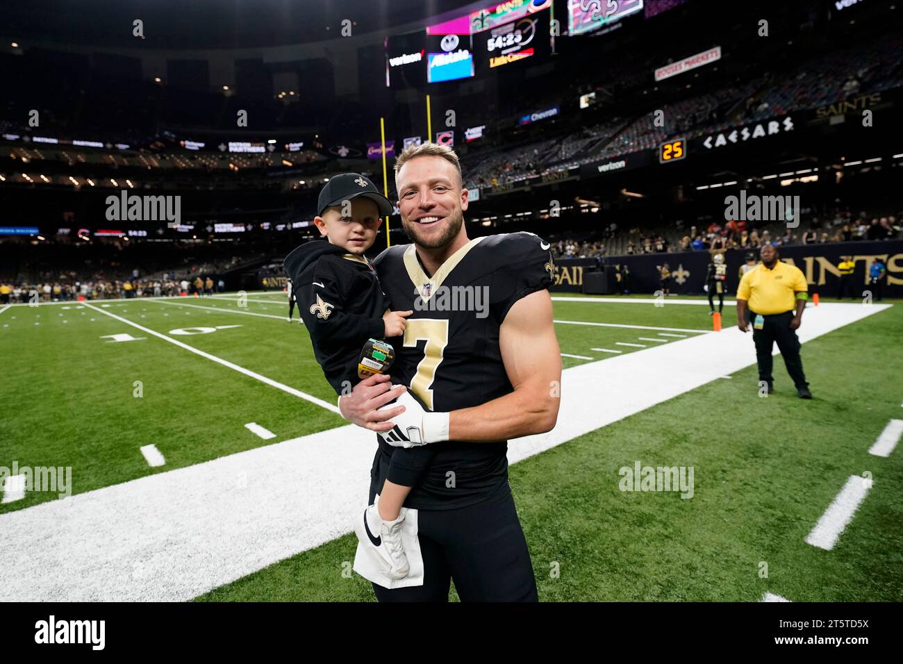 New Orleans Saints quarterback Taysom Hill holds his son Beau, 3, before an NFL football game ...