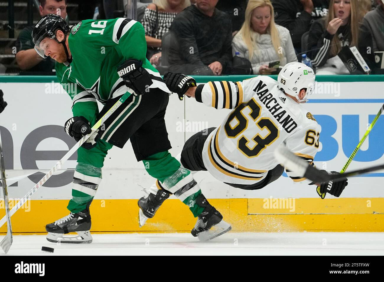 Boston Bruins left wing Brad Marchand (63) loses his footing while ...