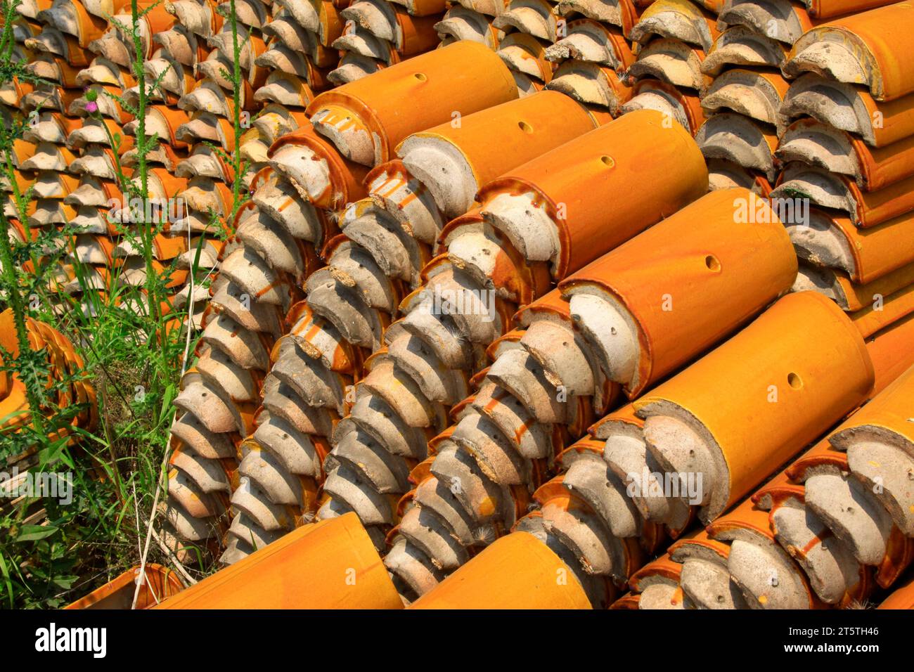 Yellow glazed tiles stacked in the grass Stock Photo - Alamy