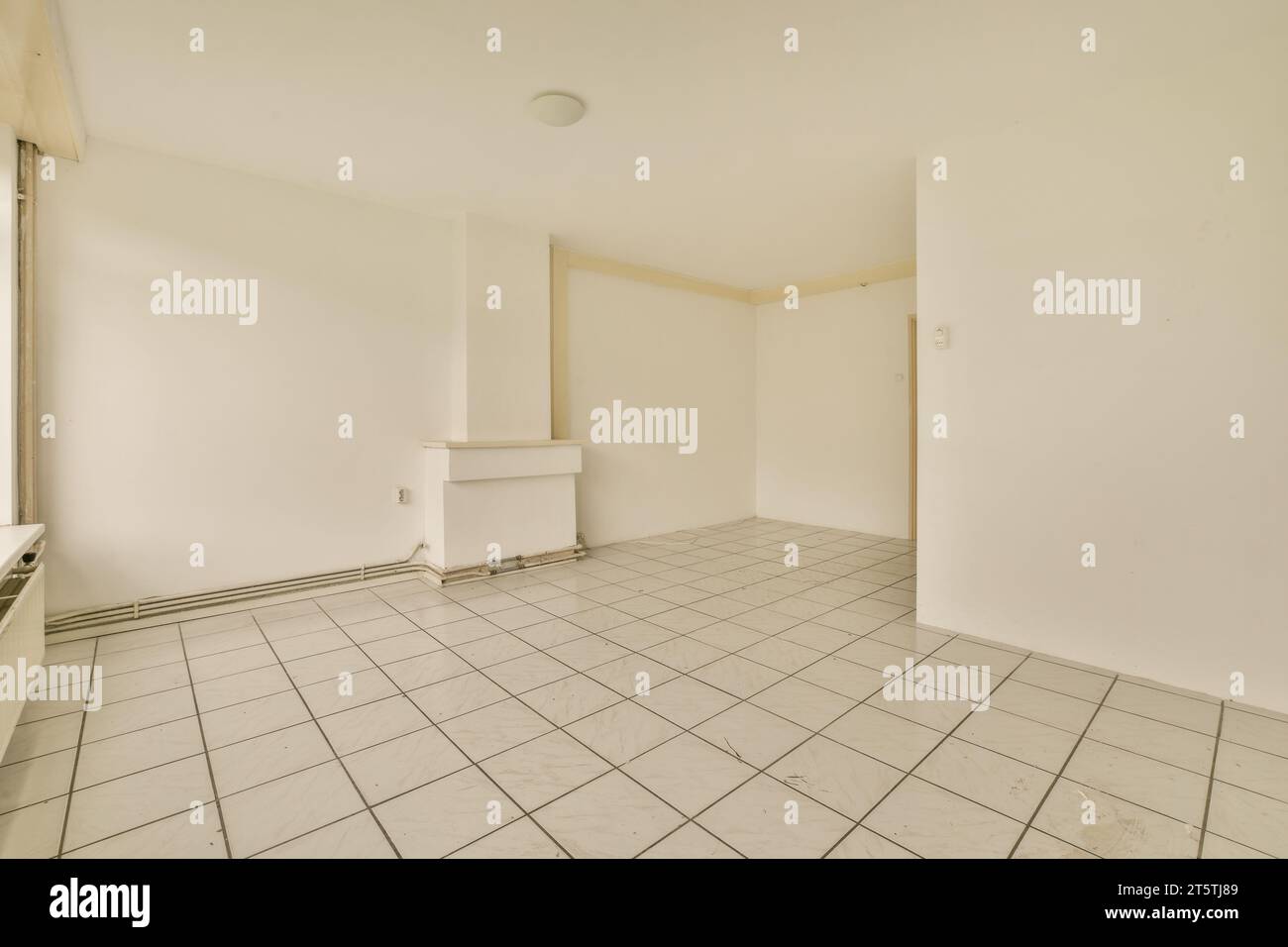 an empty room with white walls and tile flooring on the floor, there is ...