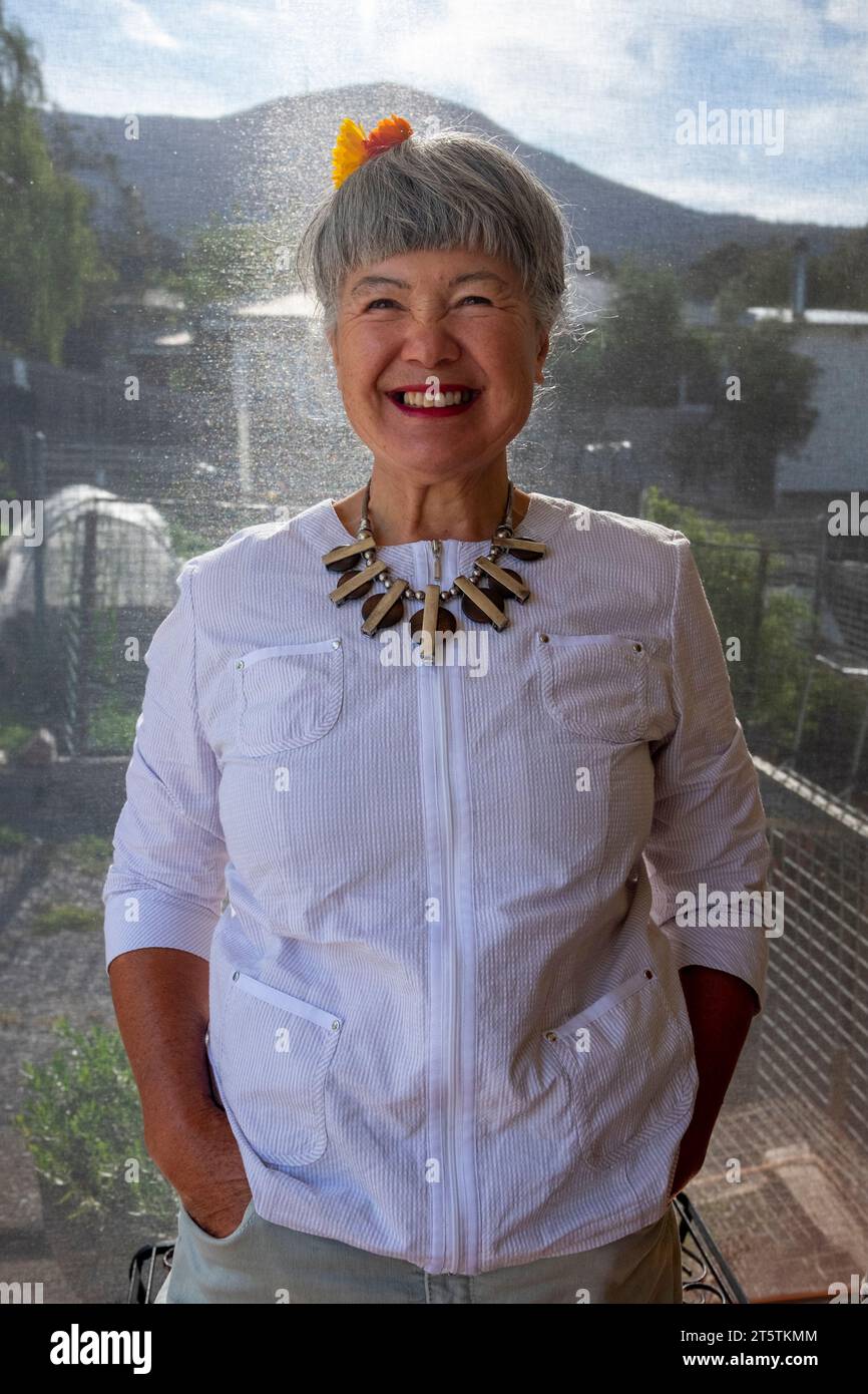 A smiling happy 68 year old Australian Chinese Italian Eurasian woman ...