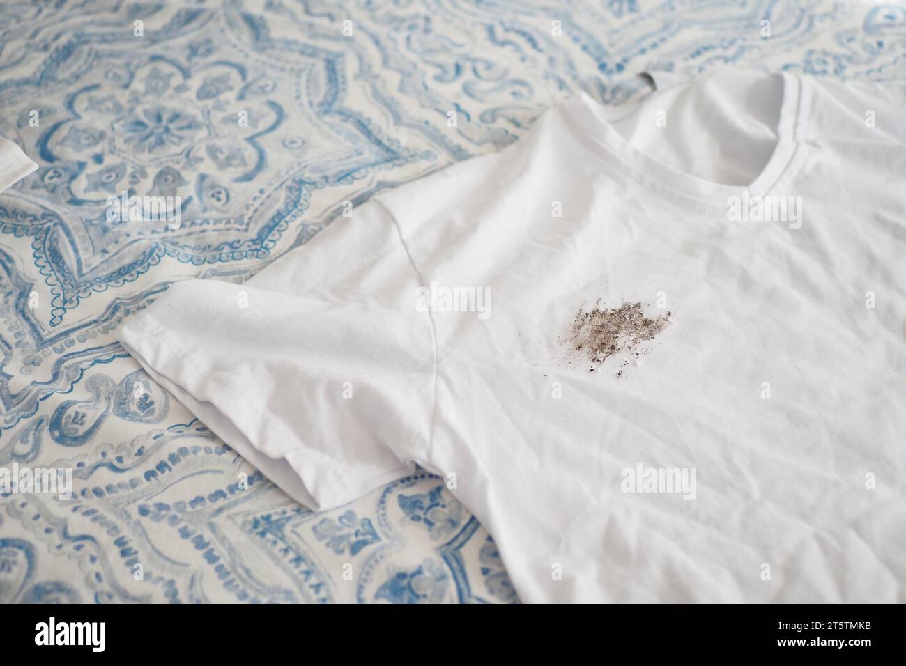 making stain on a shite shirt on bed Stock Photo - Alamy