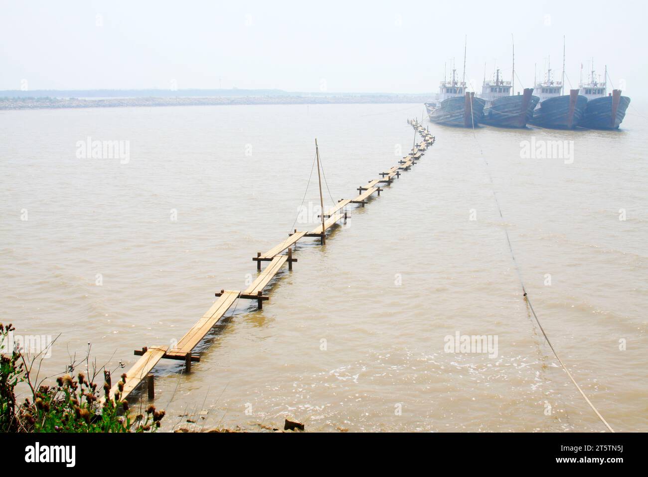 Fishing boats and bridge Stock Photo - Alamy