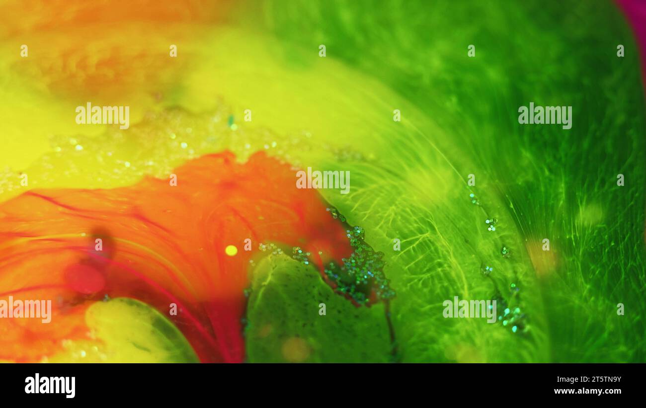 Color fluid ink water mix neon green dye blend Stock Photo - Alamy