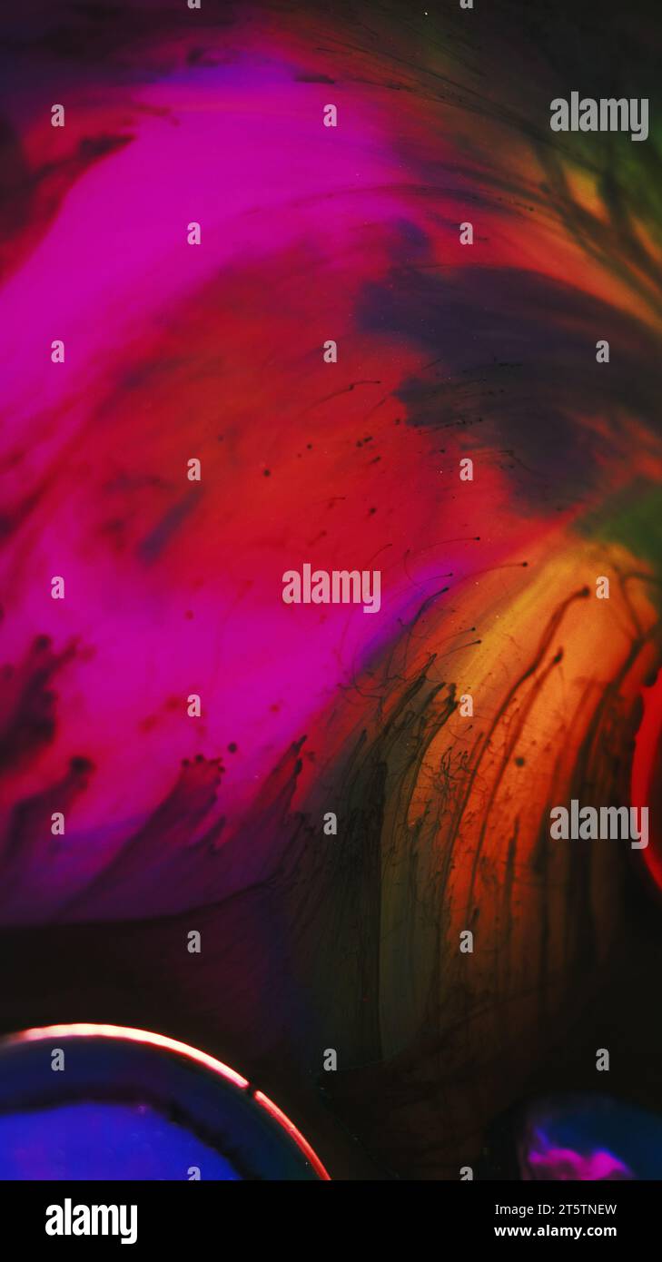 Paint drop ink water splash neon oil fluid mix Stock Photo - Alamy