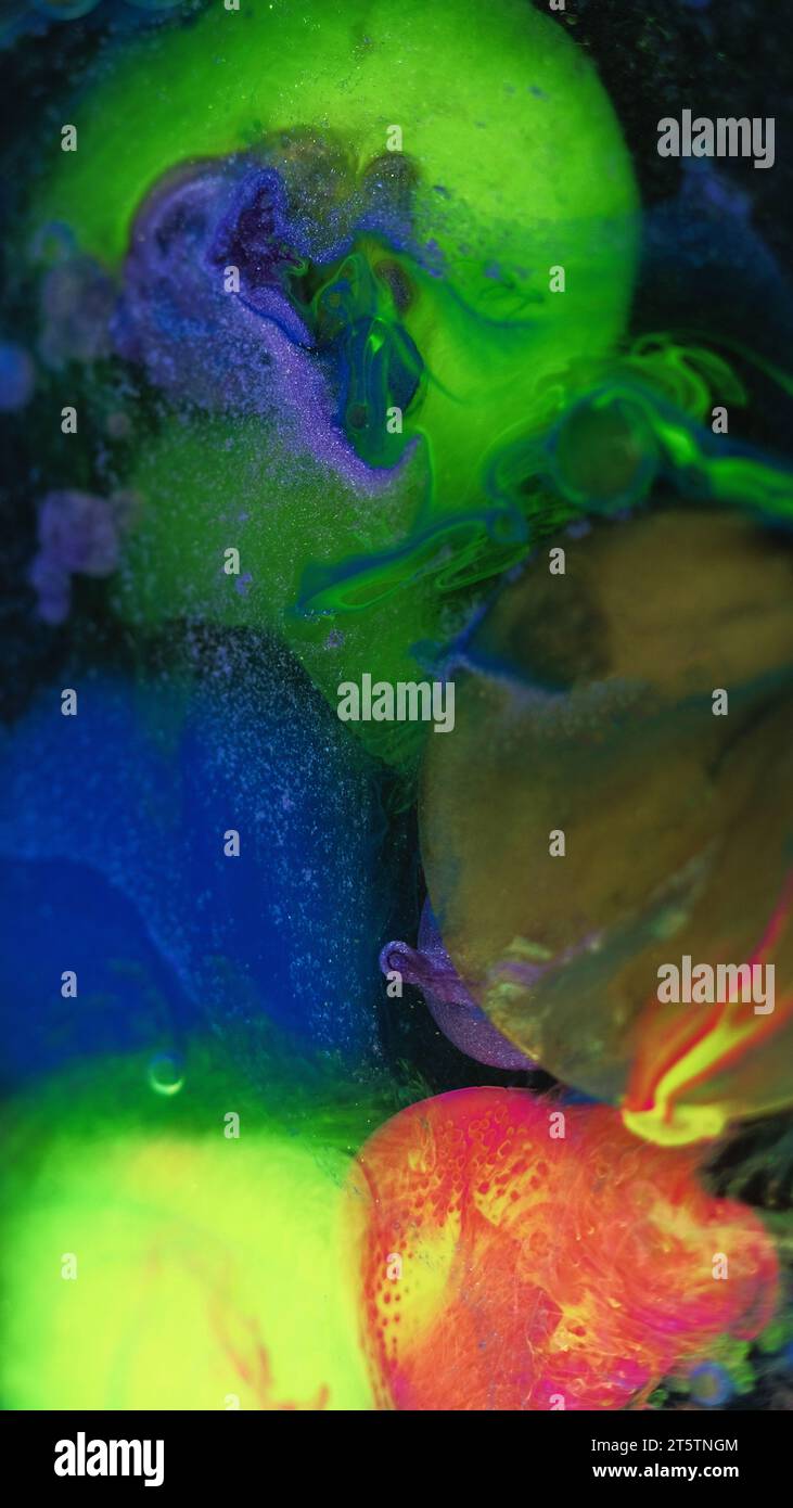 Ink water drop oil bubbles neon glitter paint mix Stock Photo - Alamy