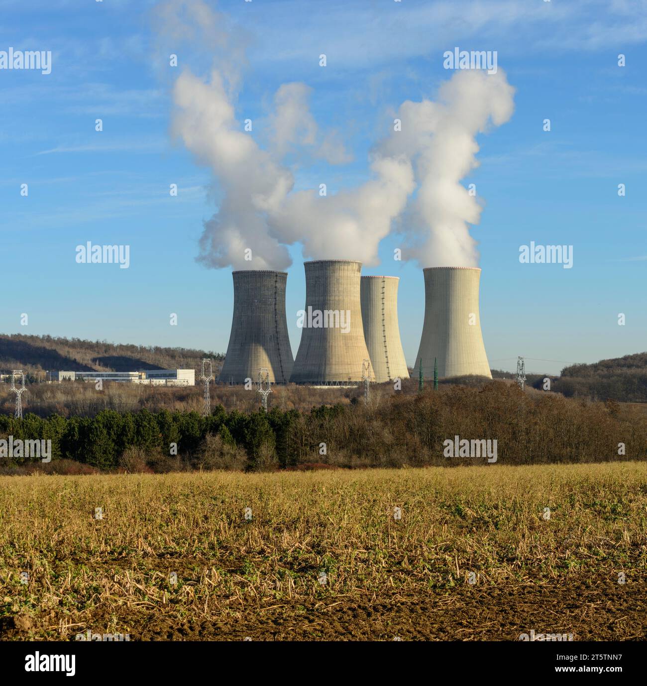 Cooling towers of nuclear power plant. High voltage power lines ...