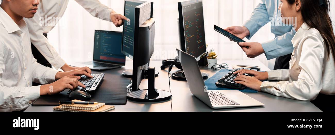 Software development team working together in office, coding script ...