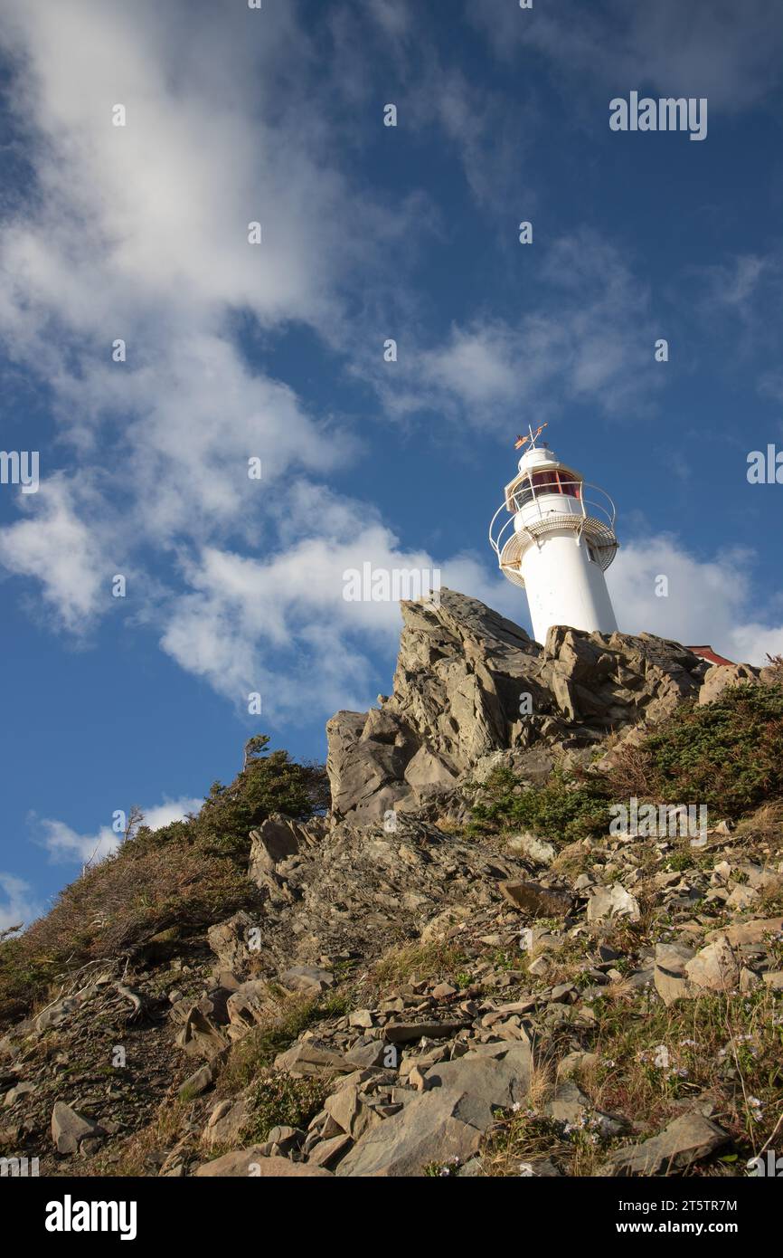 Lobster Cove Lighthouse on a rocky cliff in west Newfoundland Stock ...