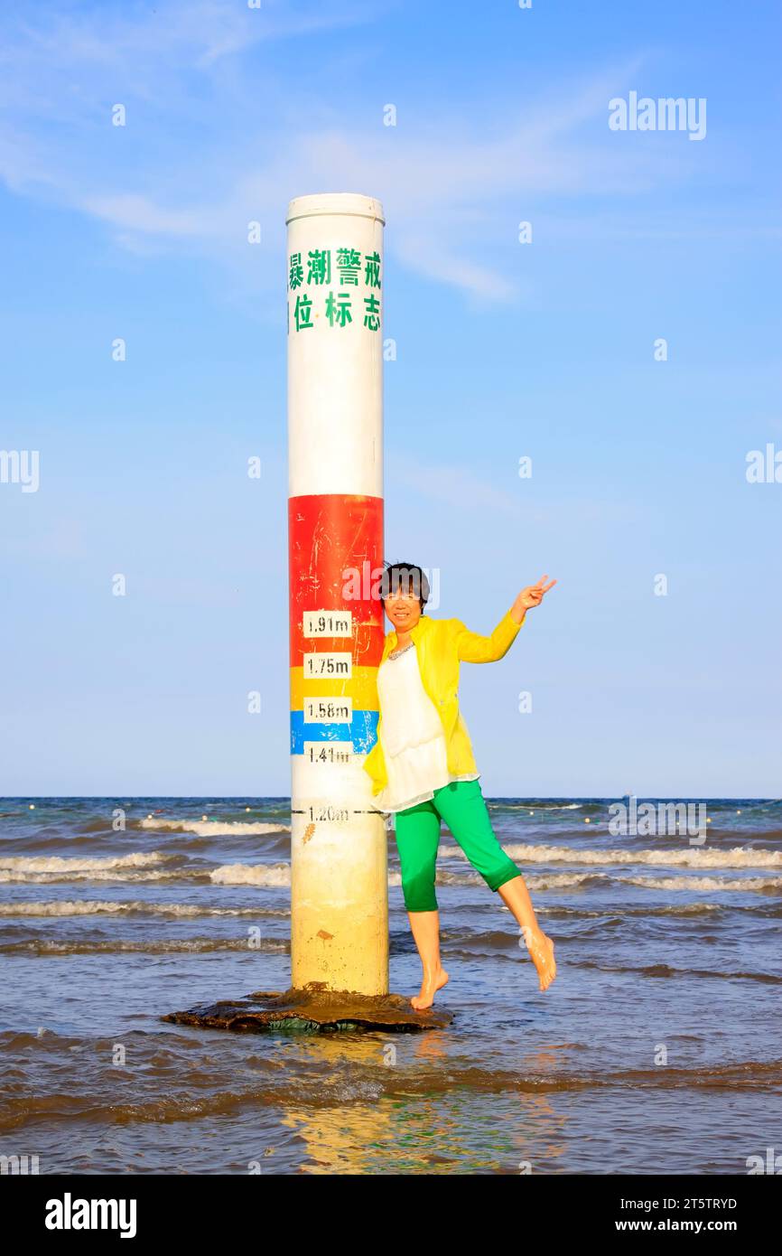 JINGTANG PORT - AUGUST 29: a woman visiting nearby storm surge alert ...