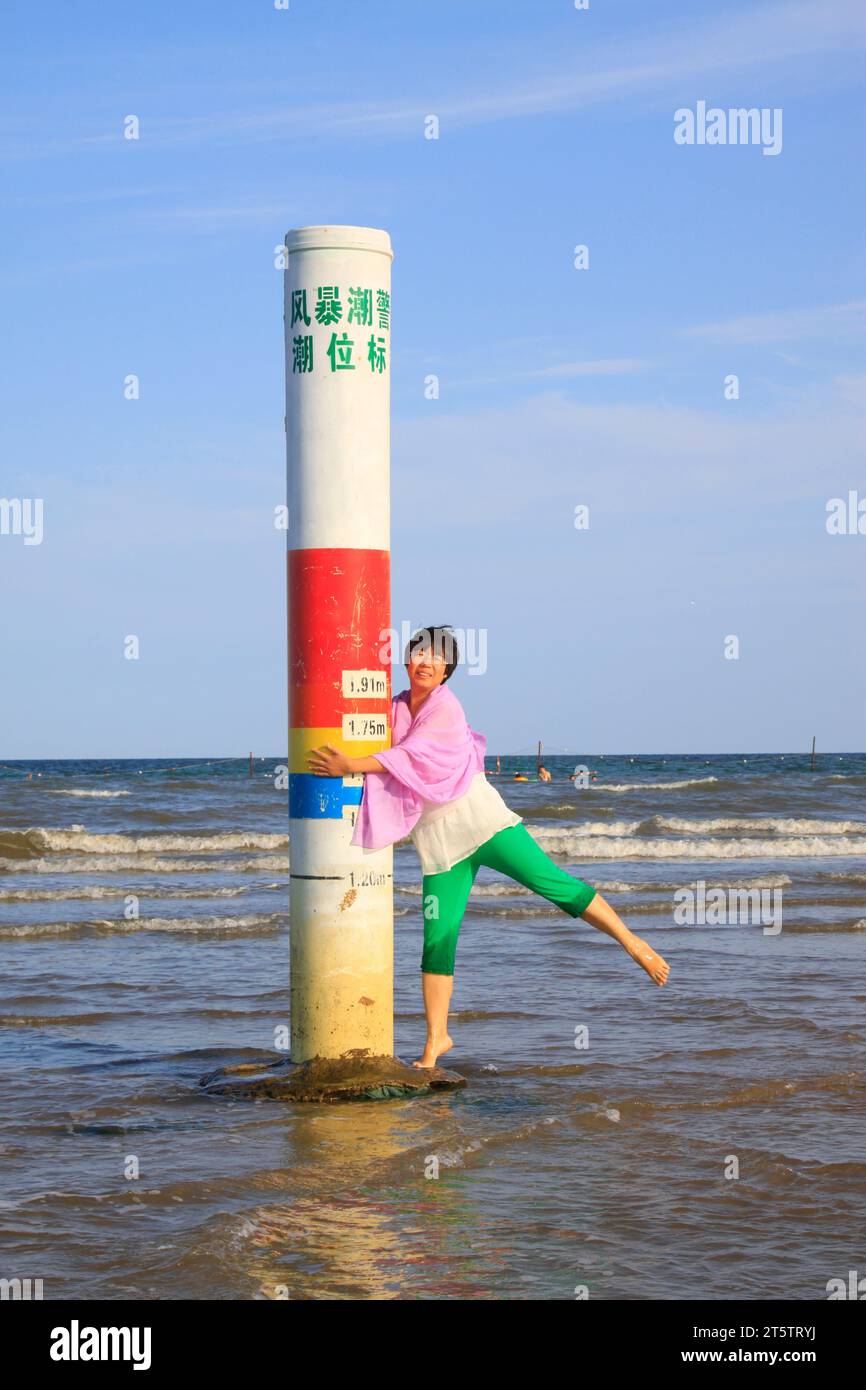 JINGTANG PORT - AUGUST 29: a woman visiting nearby storm surge alert ...