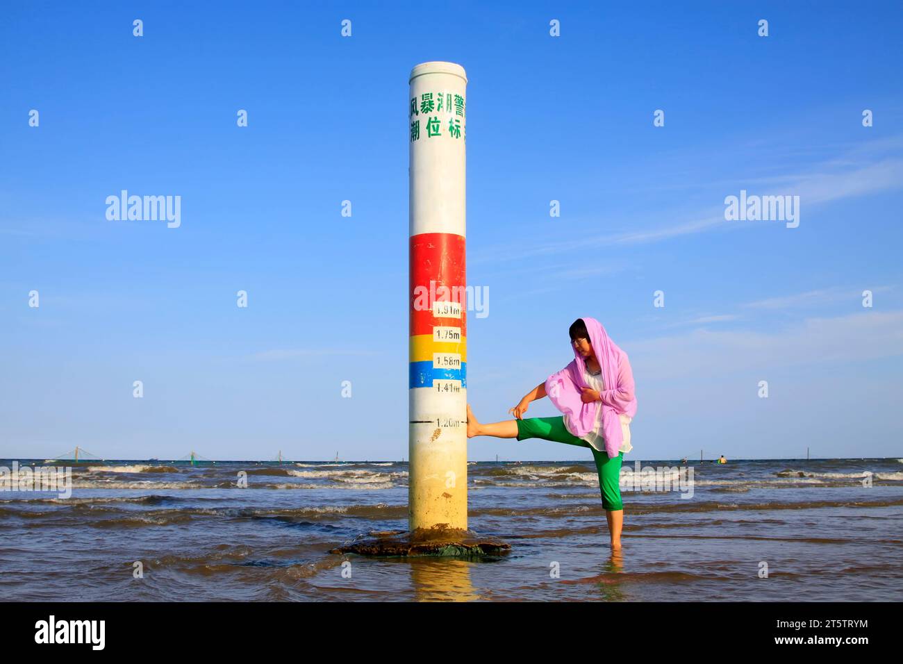 JINGTANG PORT - AUGUST 29: a woman visiting nearby storm surge alert ...