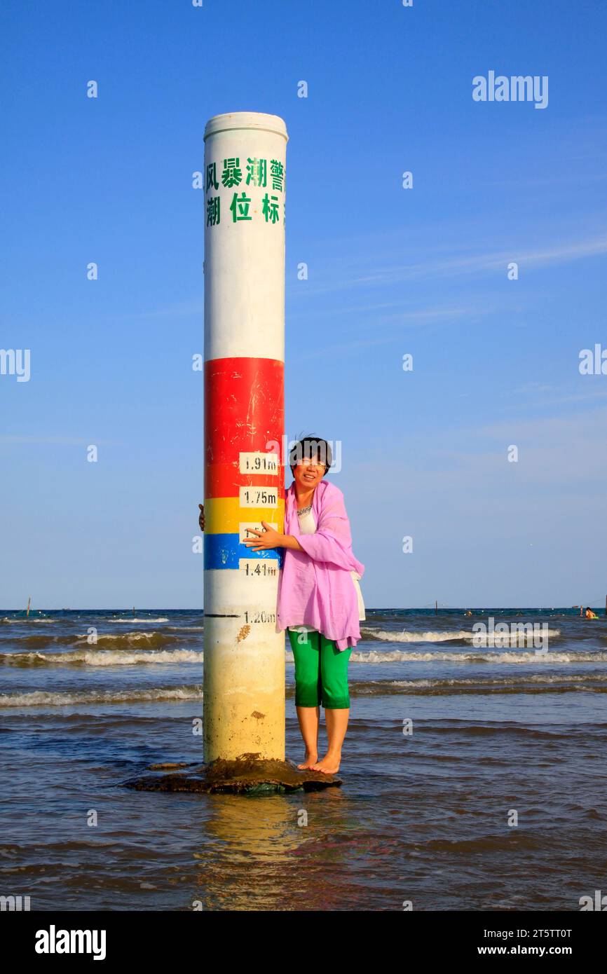 JINGTANG PORT - AUGUST 29: a woman visiting nearby storm surge alert ...