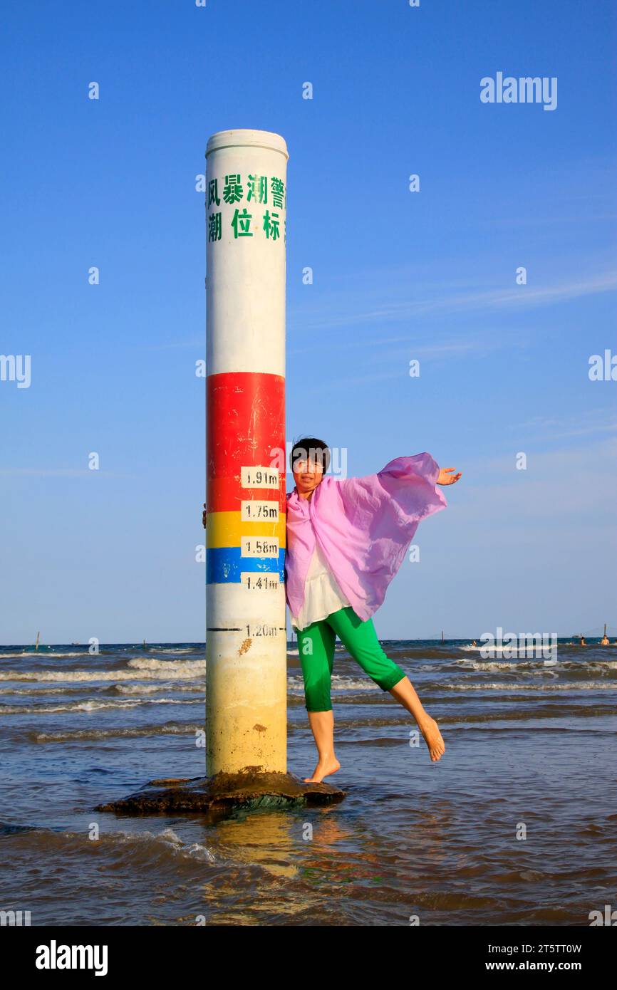 JINGTANG PORT - AUGUST 29: a woman visiting nearby storm surge alert ...