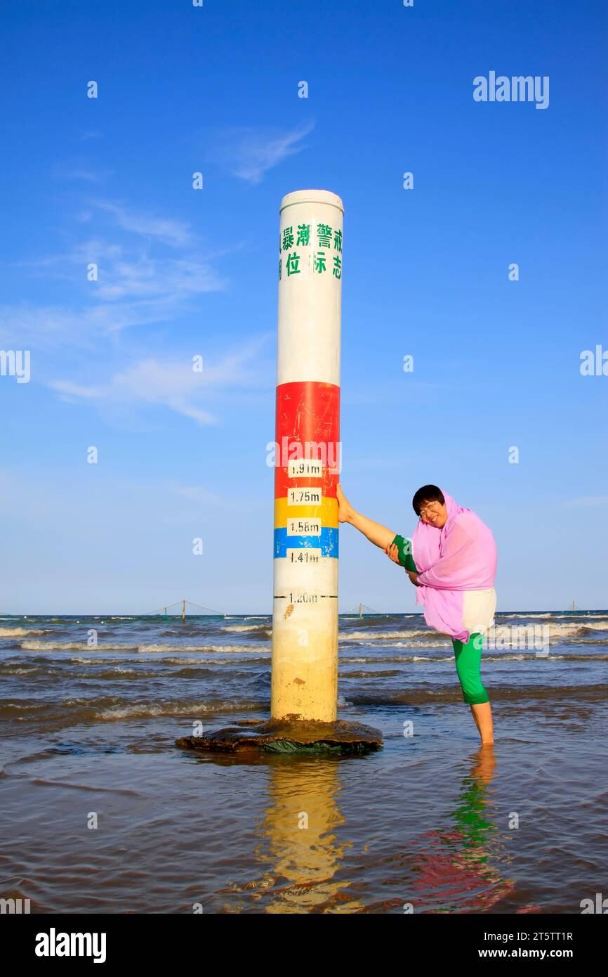 JINGTANG PORT - AUGUST 29: a woman visiting nearby storm surge alert ...