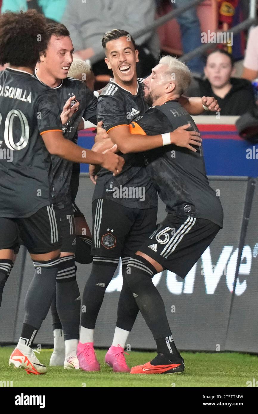 Houston Dynamo midfielder Amine Bassi, center, receives a hug from ...