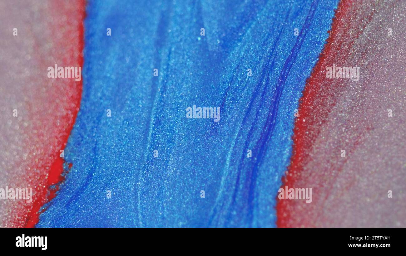 Glitter ink wave fluid spill blue red paint flow Stock Photo - Alamy
