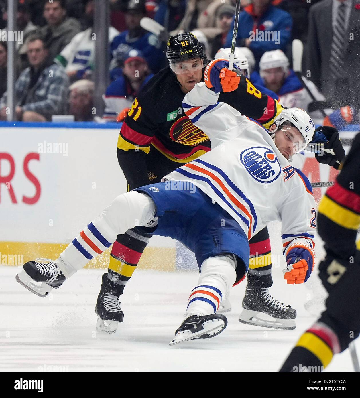Edmonton Oilers' Leon Draisaitl, front, is hauled down by Vancouver ...