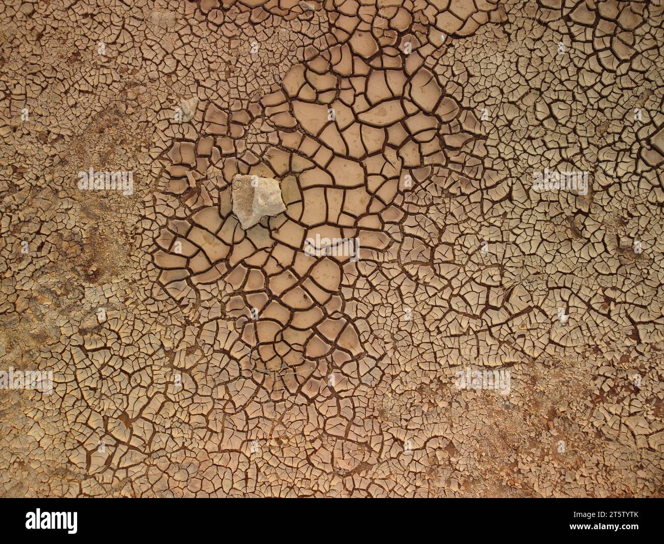 Aerial top down view on dry cracked red soil. arid, cracked red soil ...