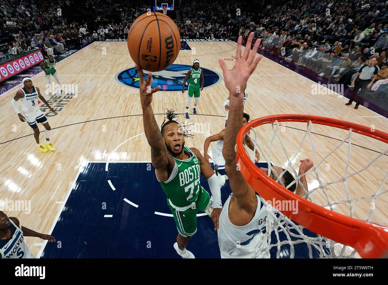 Boston Celtics forward Lamar Stevens, left, shoots against Minnesota ...