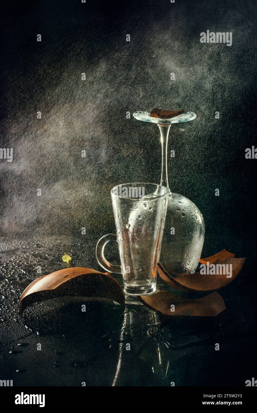 Still life with glass objects, a broken vase and water splashes Stock ...