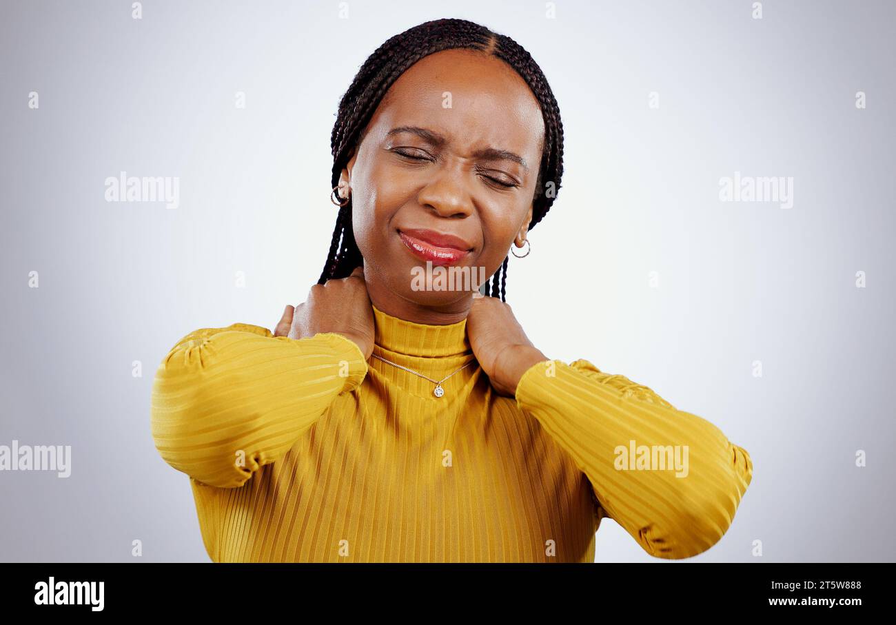 Woman, neck pain and stress or frustrated, studio and inflammation by ...
