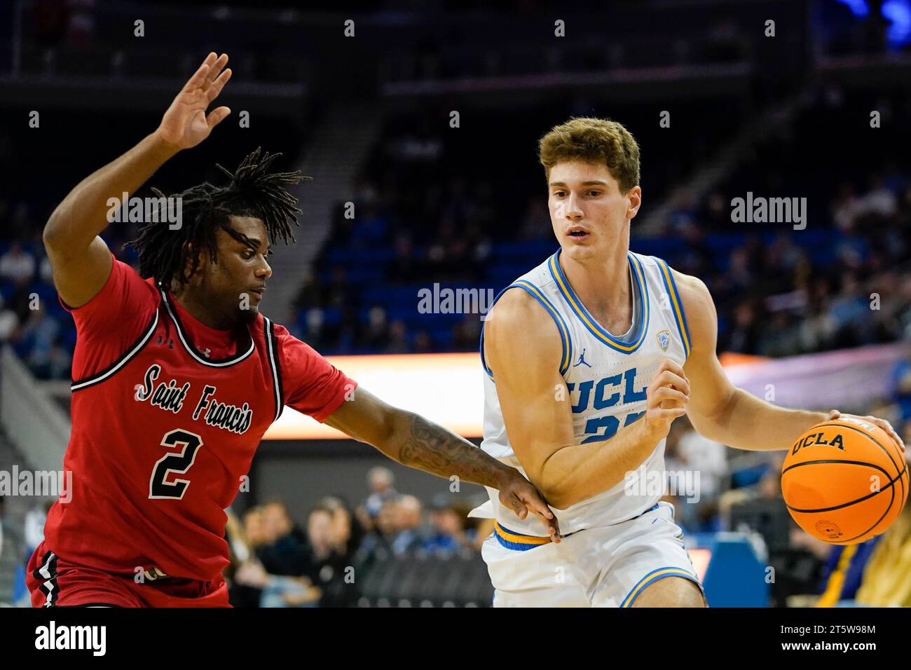 UCLA guard Jan Vide, right, drives as St. Francis guard Aaron Talbert ...