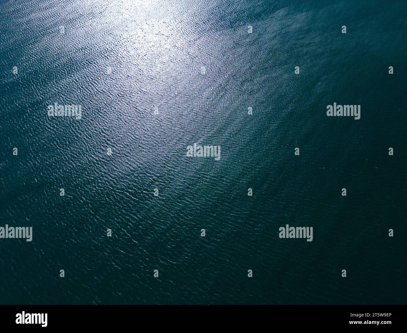 An aerial view of a majestic expanse of blue sea with lapping waves ...