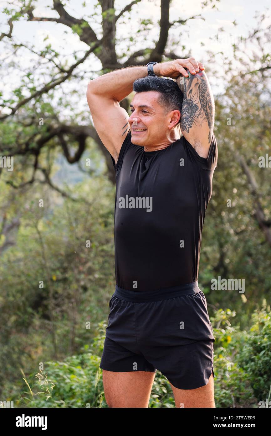 Fit model stretching arms smiling hi-res stock photography and images ...