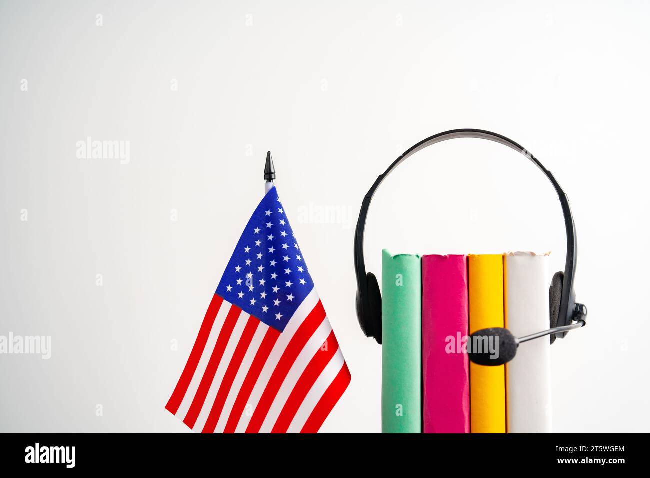 USA flag with pile of books against white background Stock Photo - Alamy