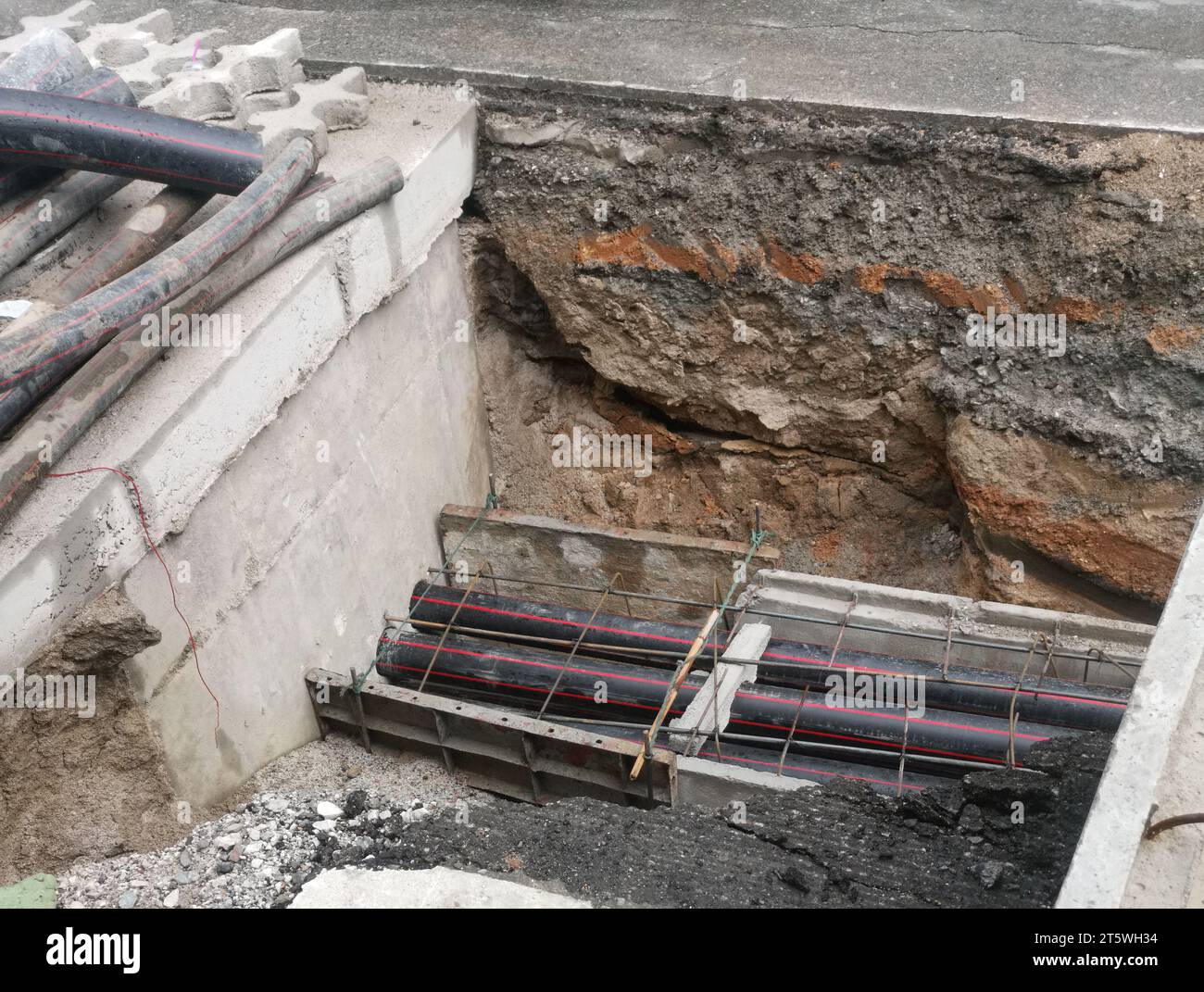Pipes in the ground under asphalt Stock Photo - Alamy