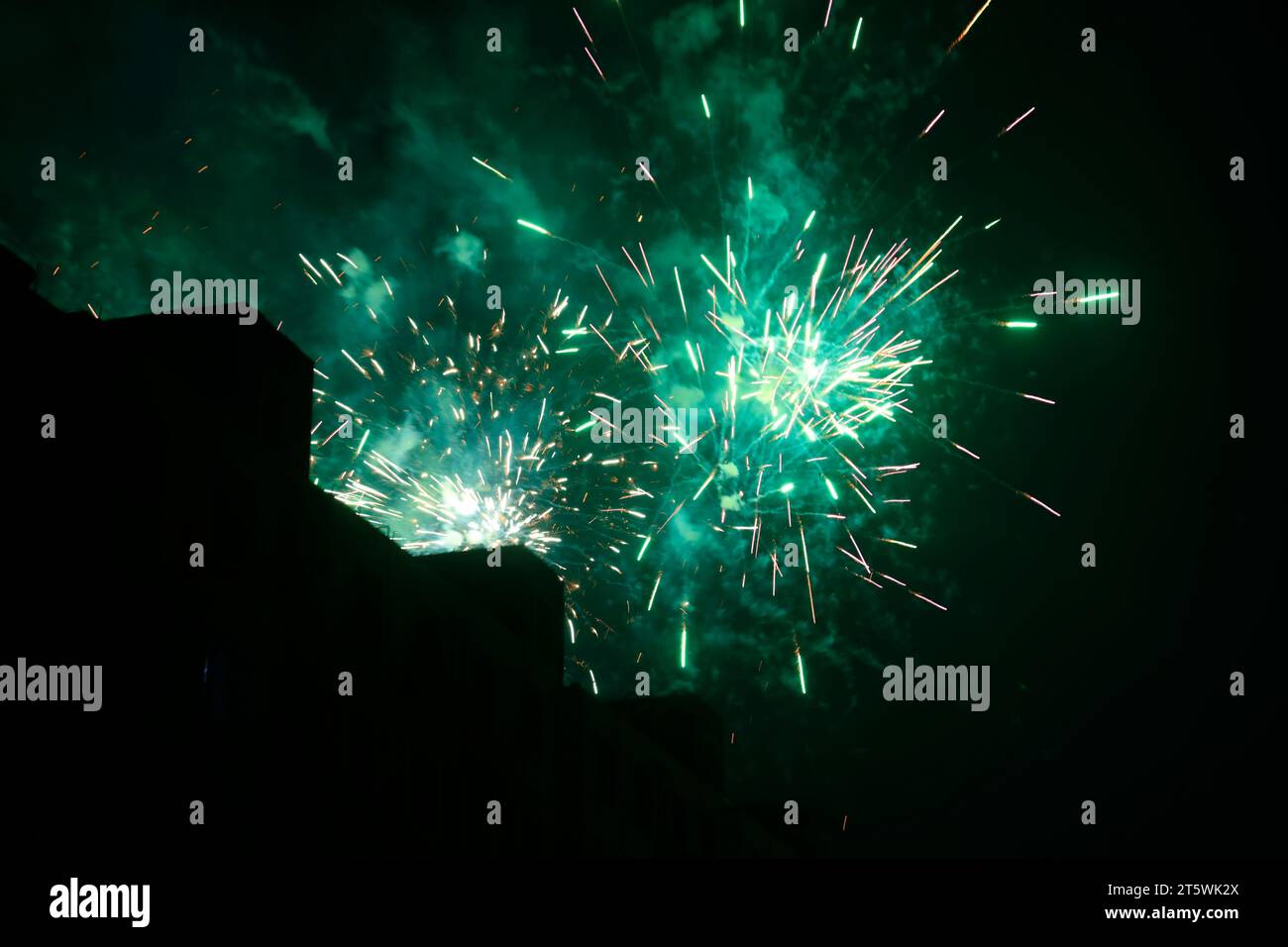 Fireworks over buildings Stock Photo - Alamy