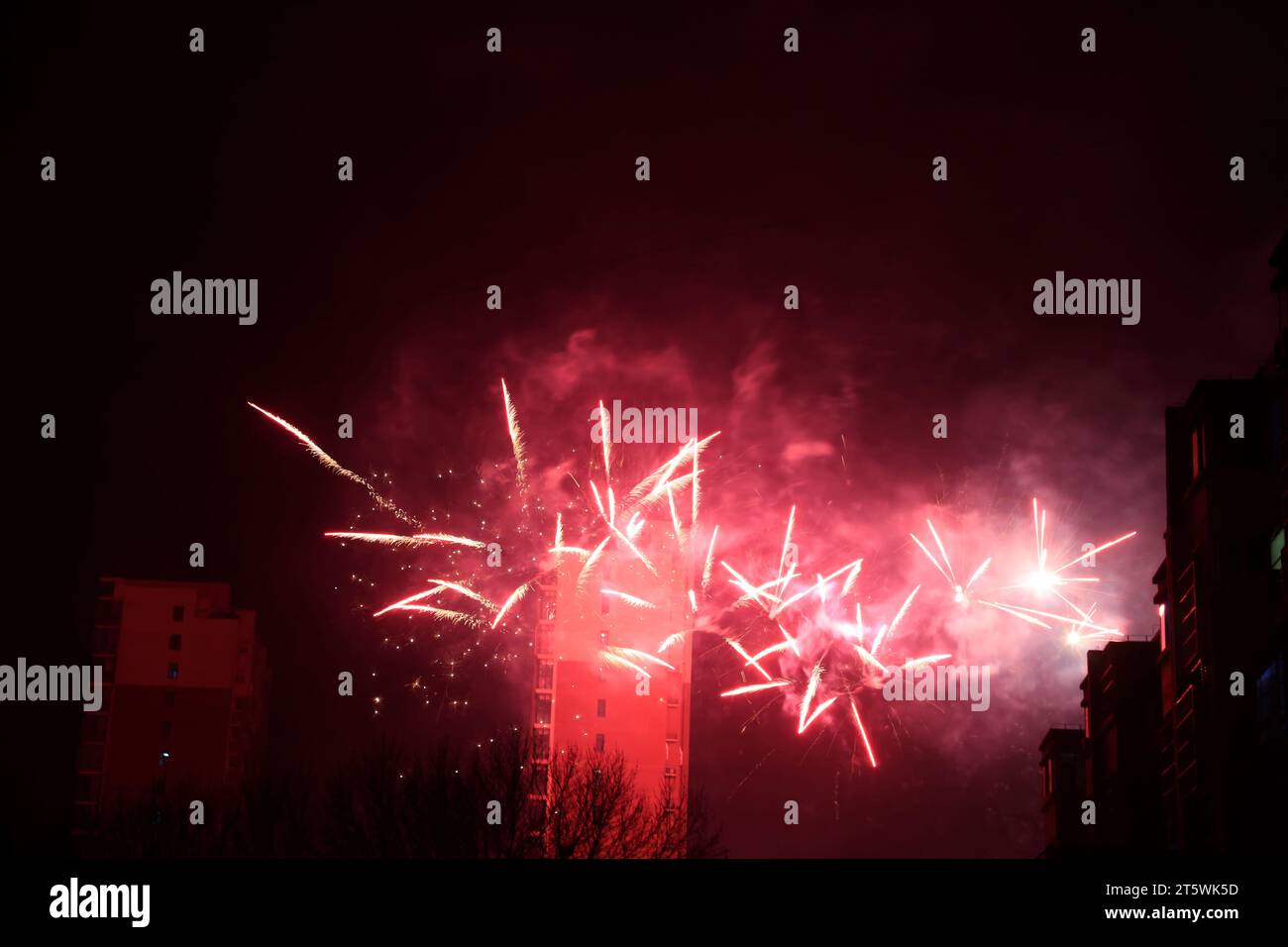 Fireworks over buildings Stock Photo - Alamy
