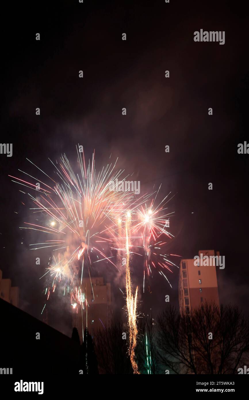 Fireworks over buildings Stock Photo - Alamy