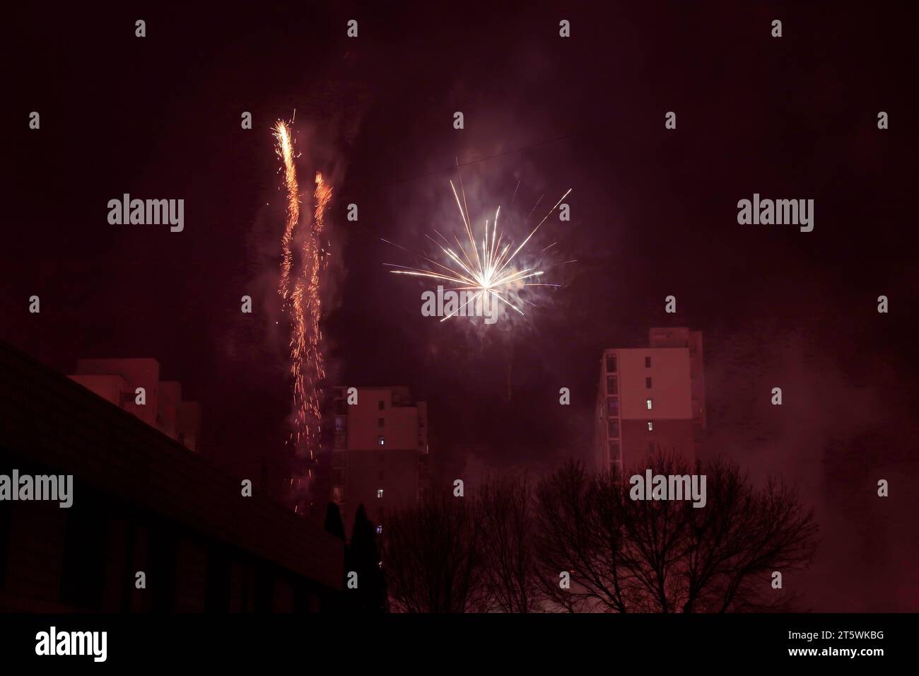 Fireworks over buildings Stock Photo - Alamy