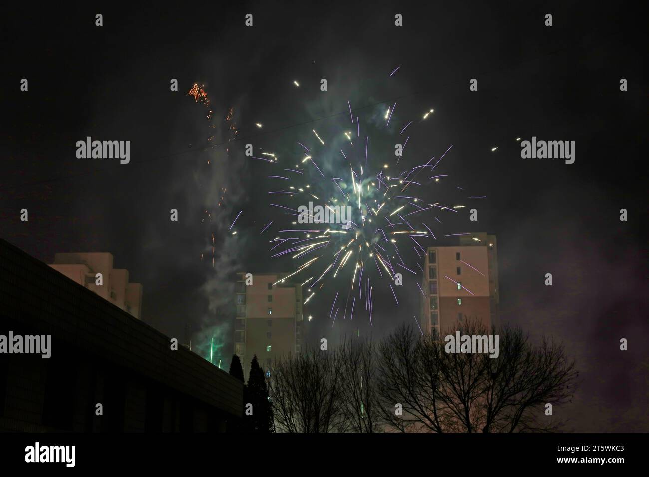 Fireworks over buildings Stock Photo - Alamy