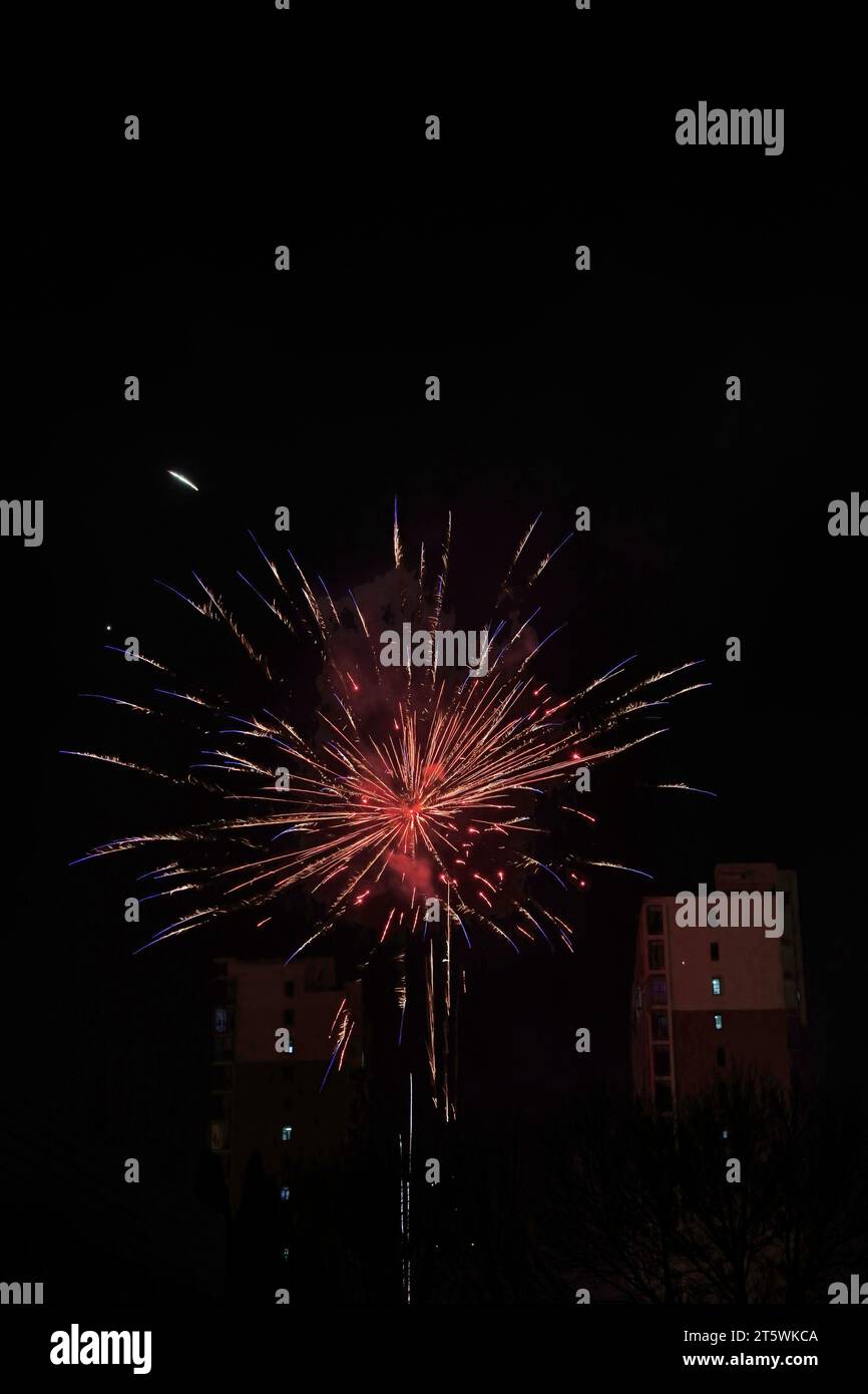 Fireworks over buildings Stock Photo - Alamy