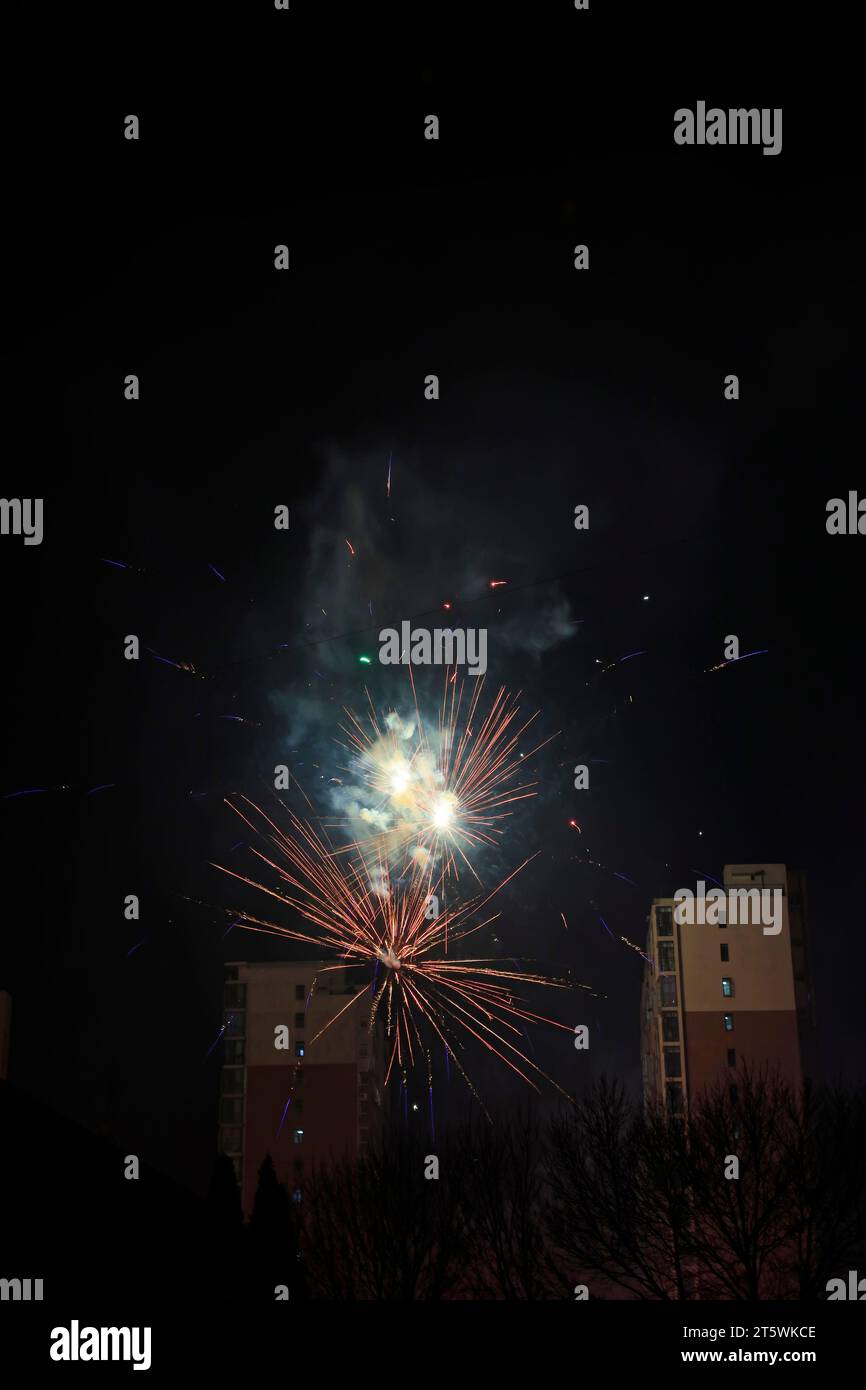 Fireworks over buildings Stock Photo - Alamy