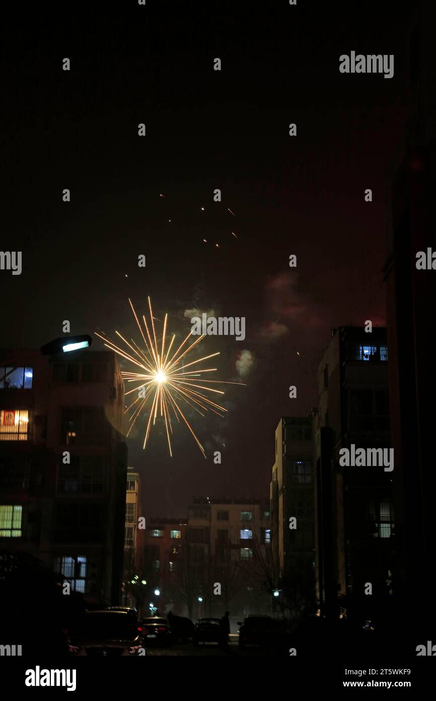 Fireworks over buildings Stock Photo - Alamy