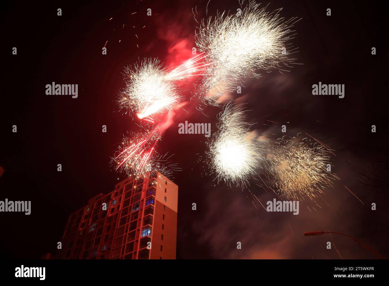 Fireworks over buildings Stock Photo - Alamy