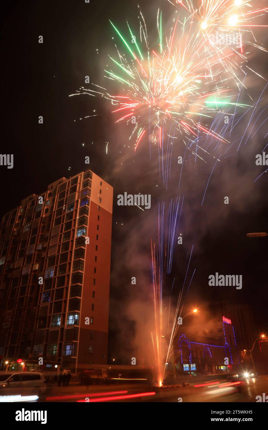 Fireworks over buildings Stock Photo - Alamy
