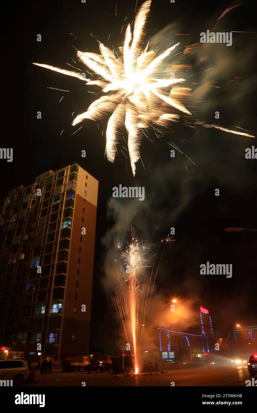 Fireworks over buildings Stock Photo - Alamy